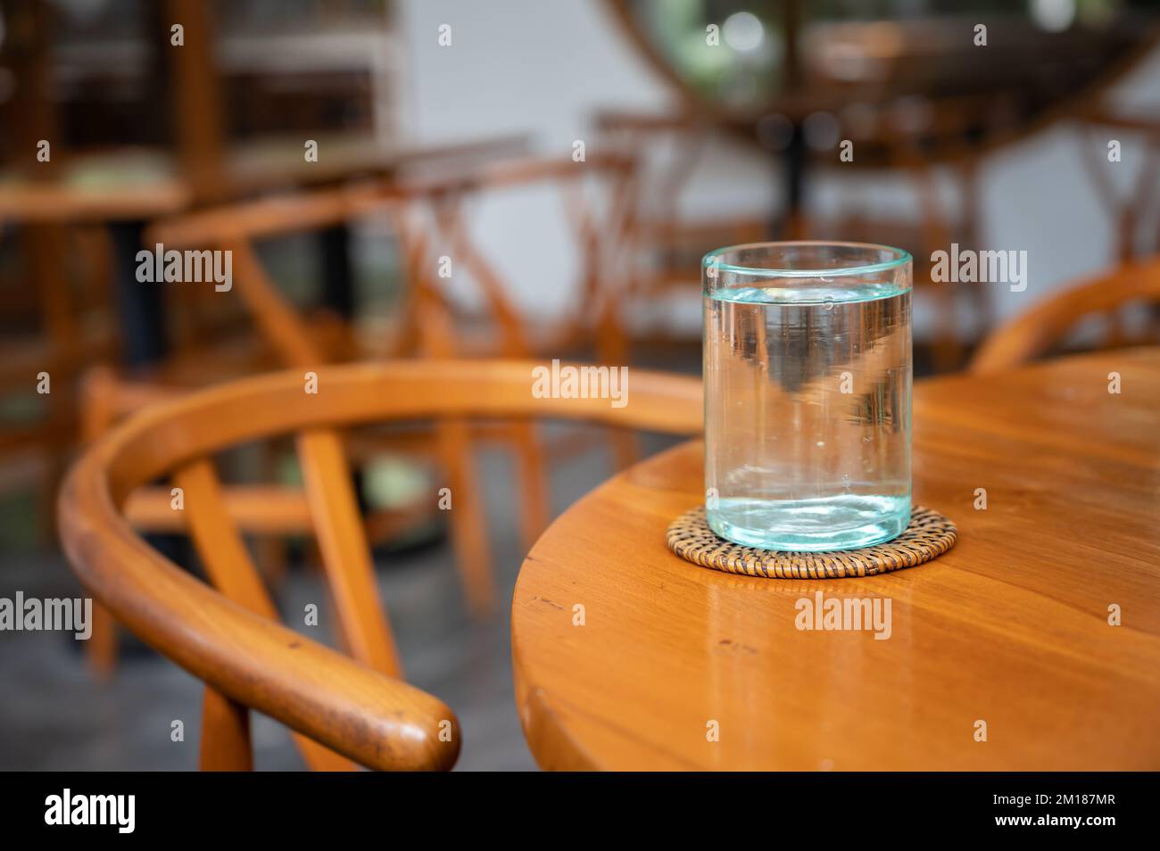 Glass of water in cafe. Beautiful interior of Bali style cafe in Ubud ...
