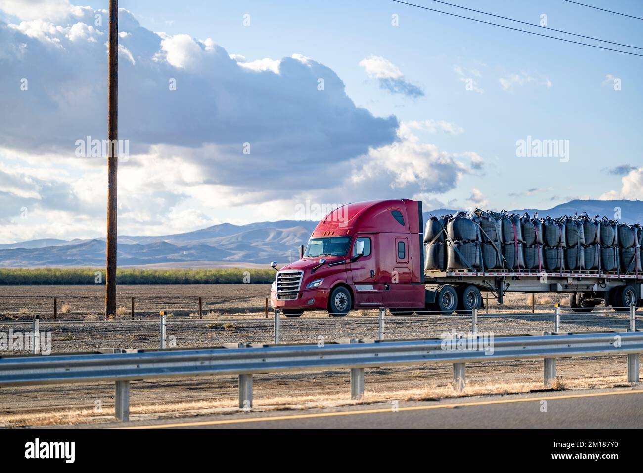 Industrial long hauler big rig red semi truck with chrome parts ...