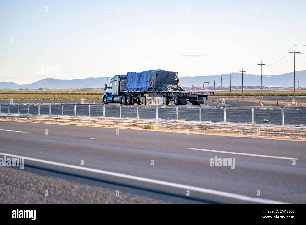 Industrial long hauler big rig blue semi truck with chrome parts ...