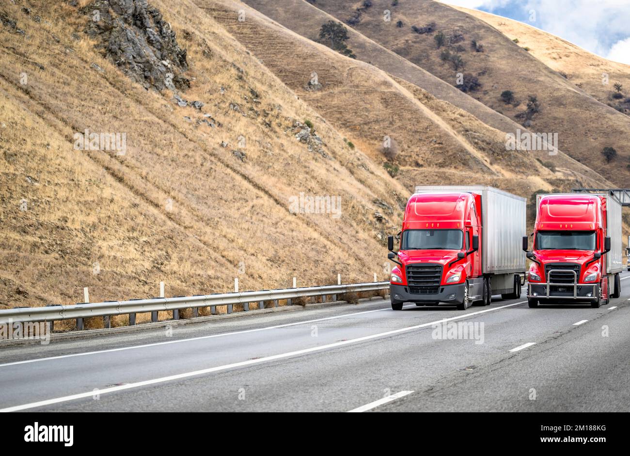 Team of two industrial professional red big rigs semi trucks ...