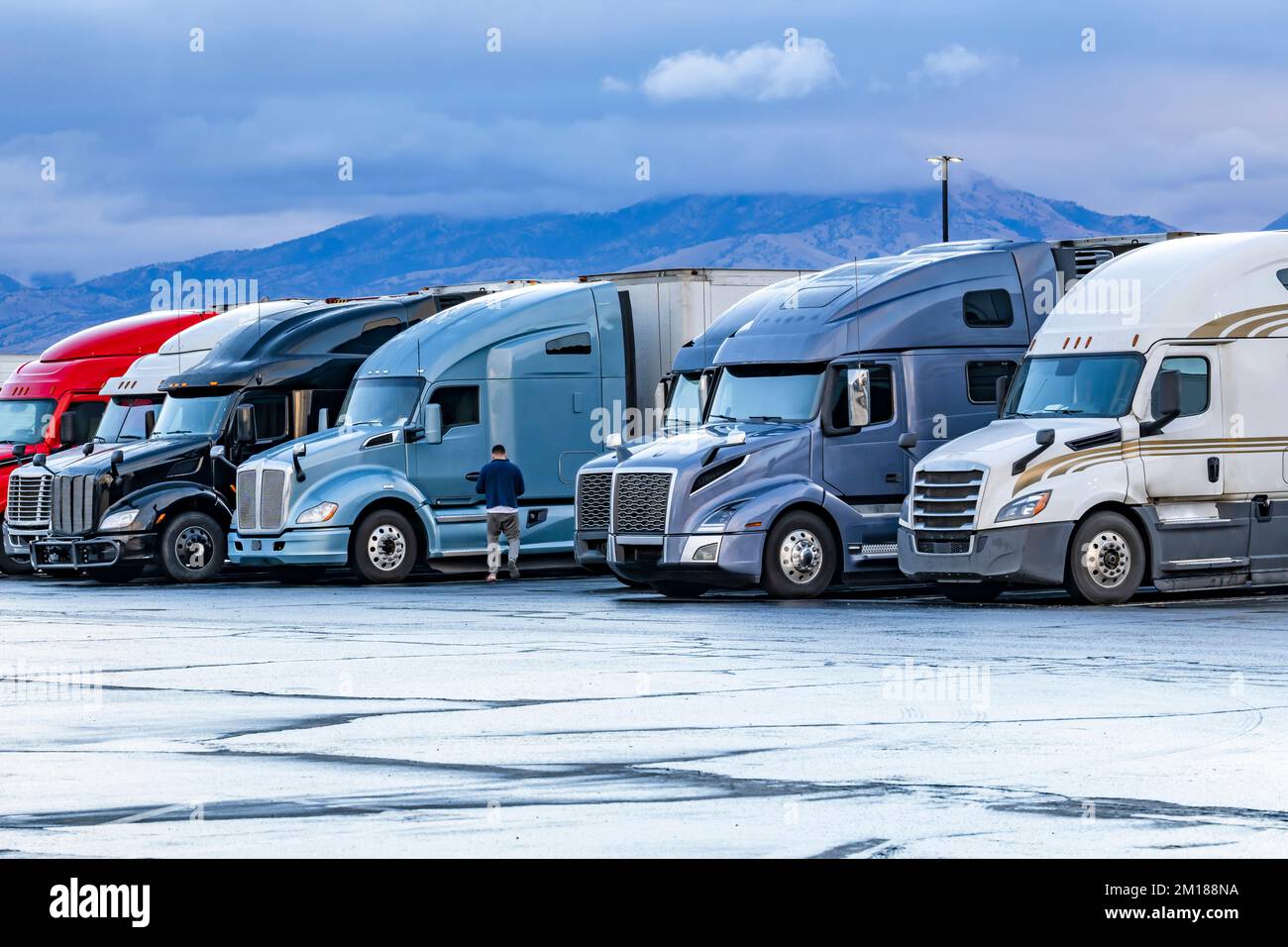 Truck driver owner operator walks towards his comfort big rig semi ...