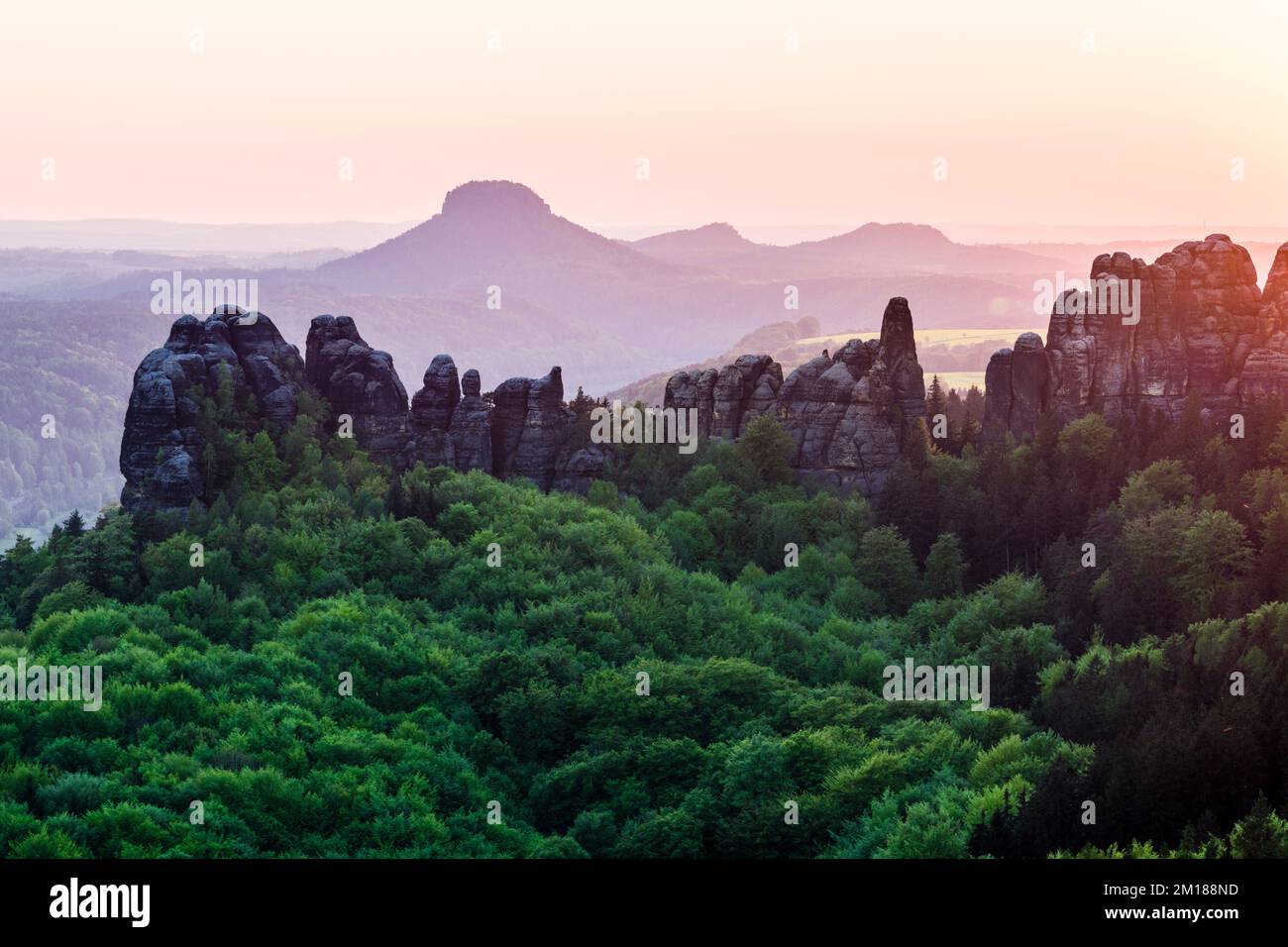 Landscape with rock formations, trees and cloudy blue sky in the ...