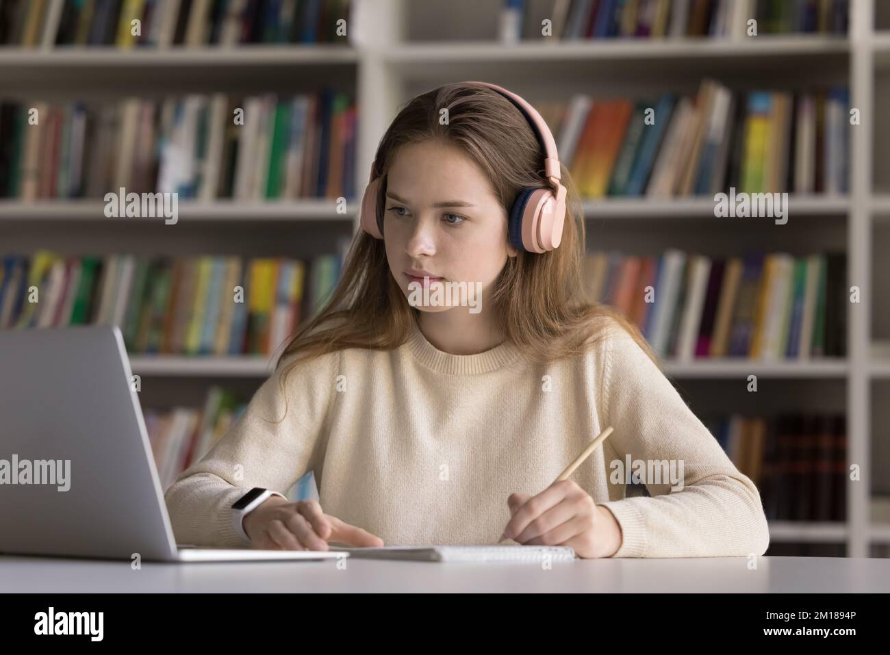 Serious hardworking smart student girl in wireless headphones Stock ...