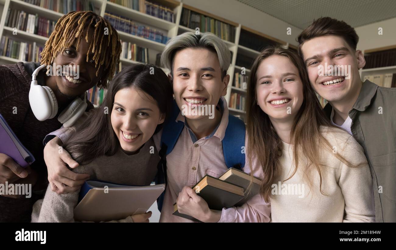Happy young classmates team having fun in college, university library ...