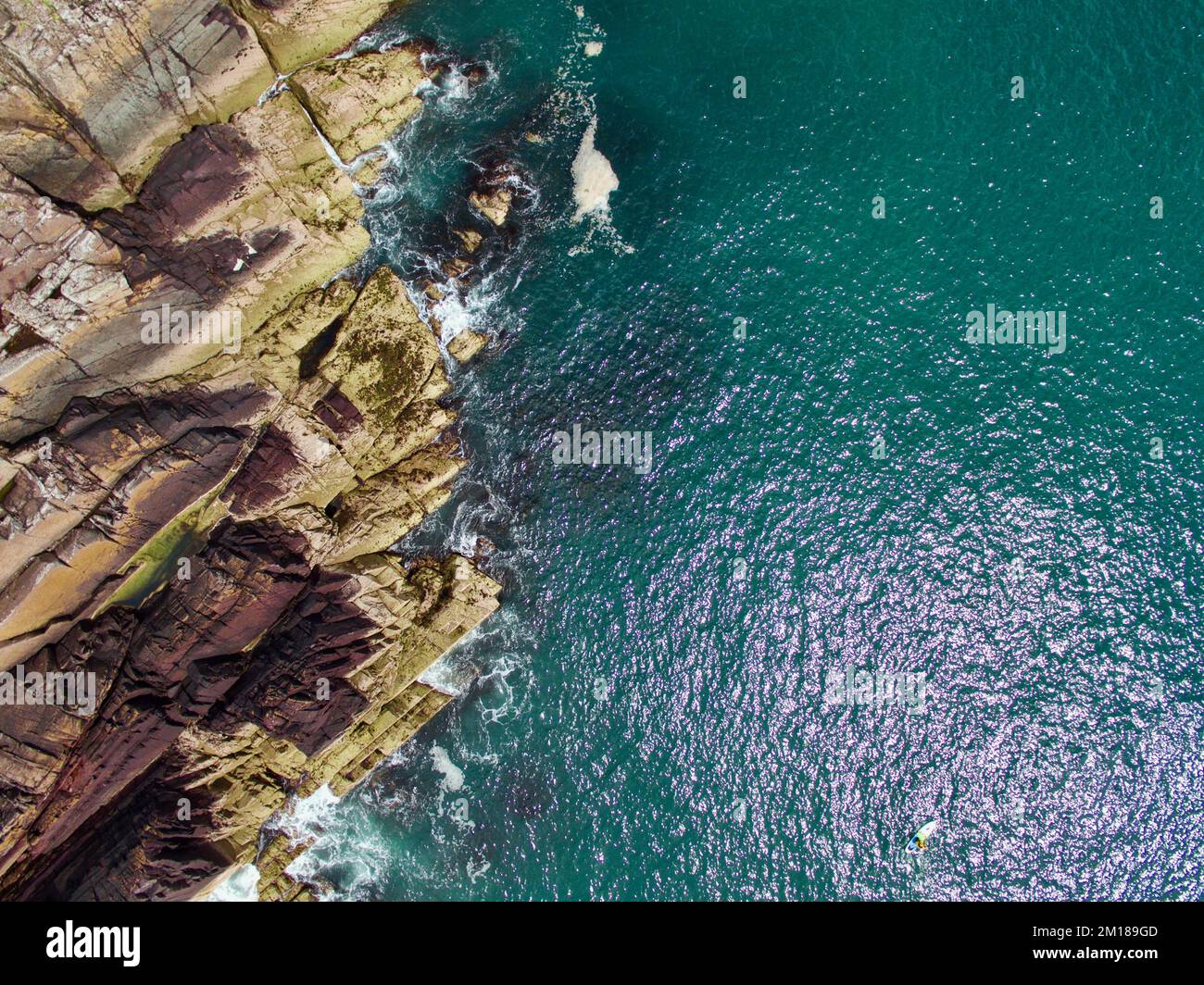 An aerial view of green cliffs facing the sea in the morning Stock ...