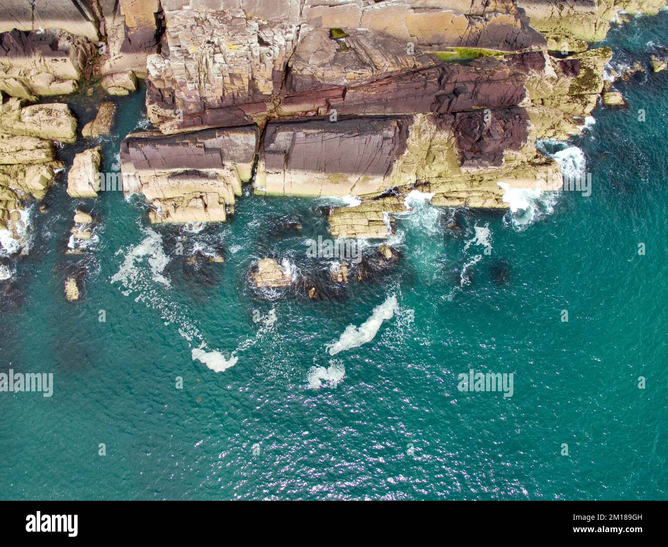 An aerial view of green cliffs facing the sea in the morning Stock ...