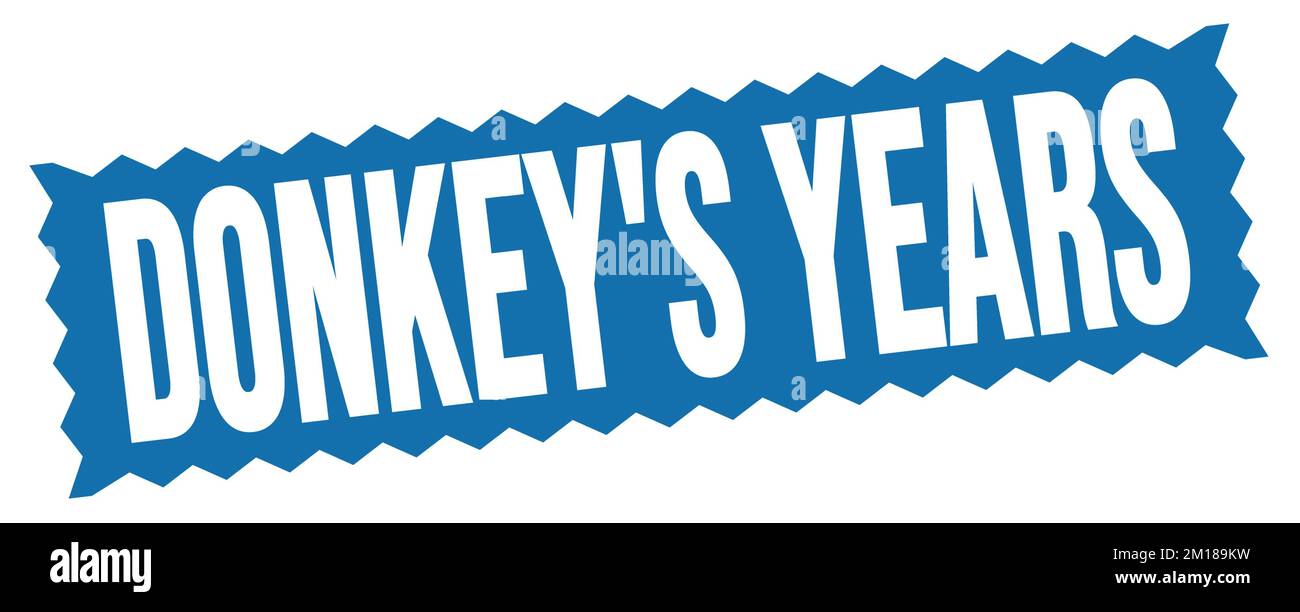 DONKEY'S YEARS text written on blue zig-zag stamp sign Stock Photo - Alamy