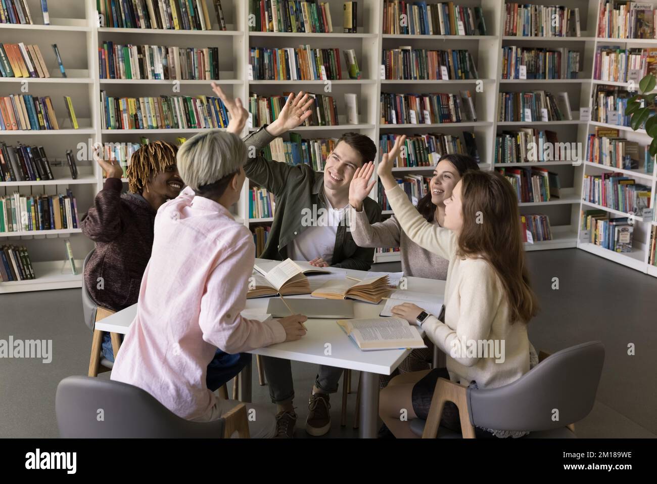 Diverse group of excited students enjoying teamwork, education process ... Diverse group of excited students enjoying teamwork, education process ...