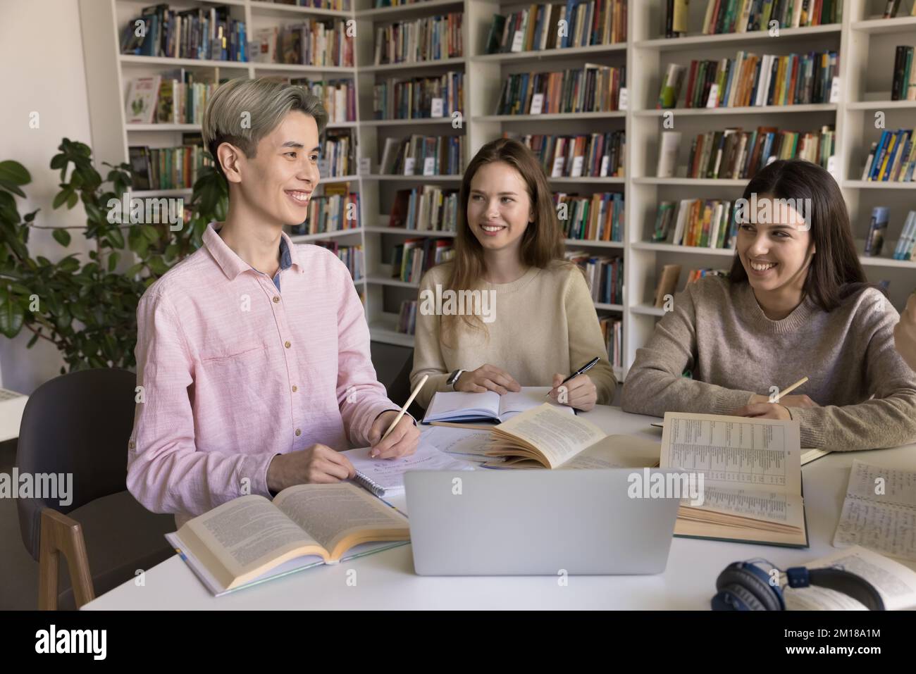 Cheerful happy students meeting in high school library Stock Photo - Alamy