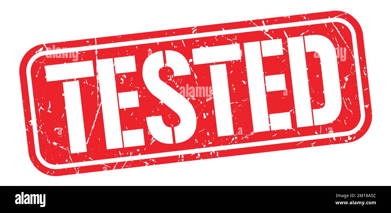 TESTED text written on red grungy stamp sign Stock Photo - Alamy