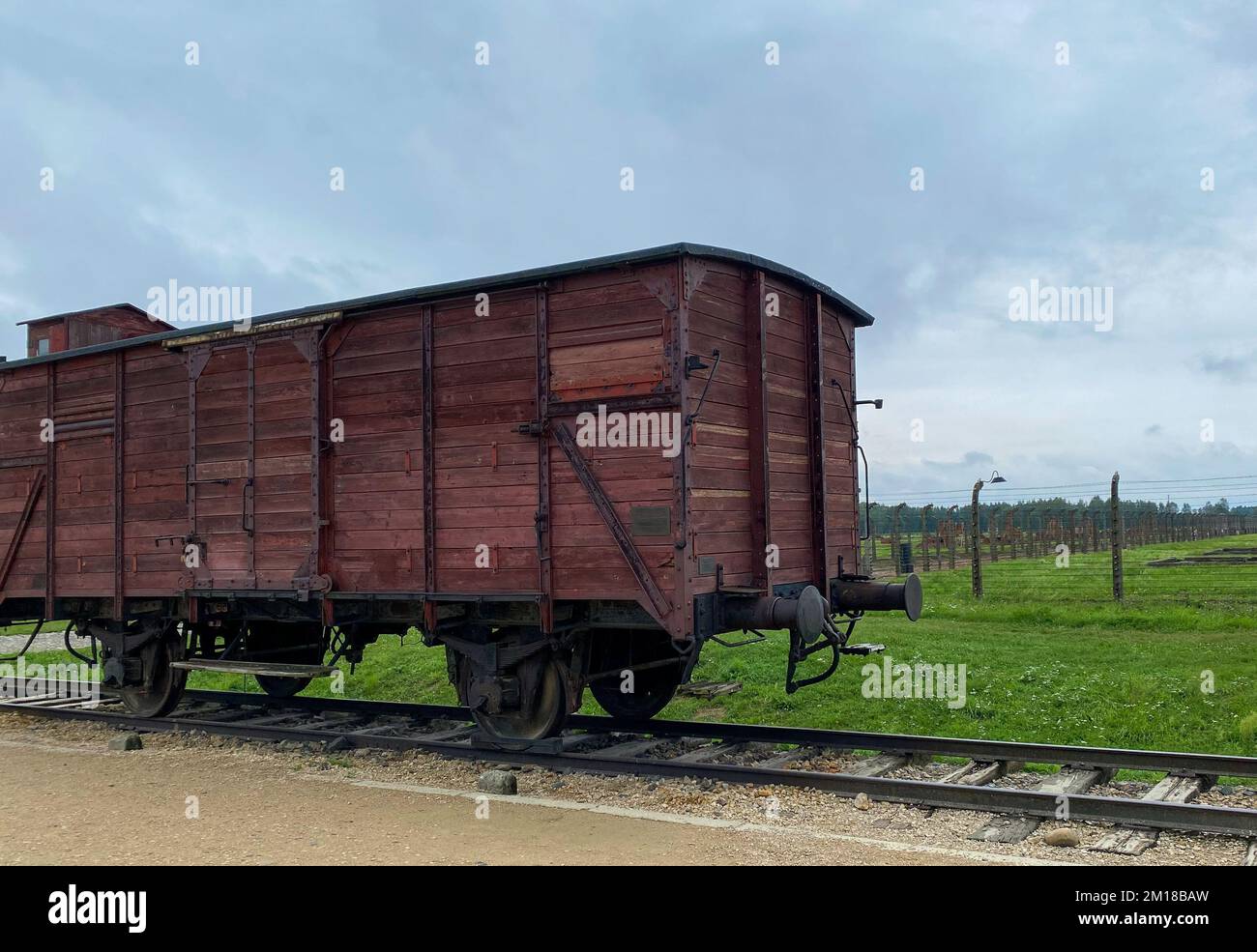 An old wooden train carriage on the railroad in the green field Stock ...