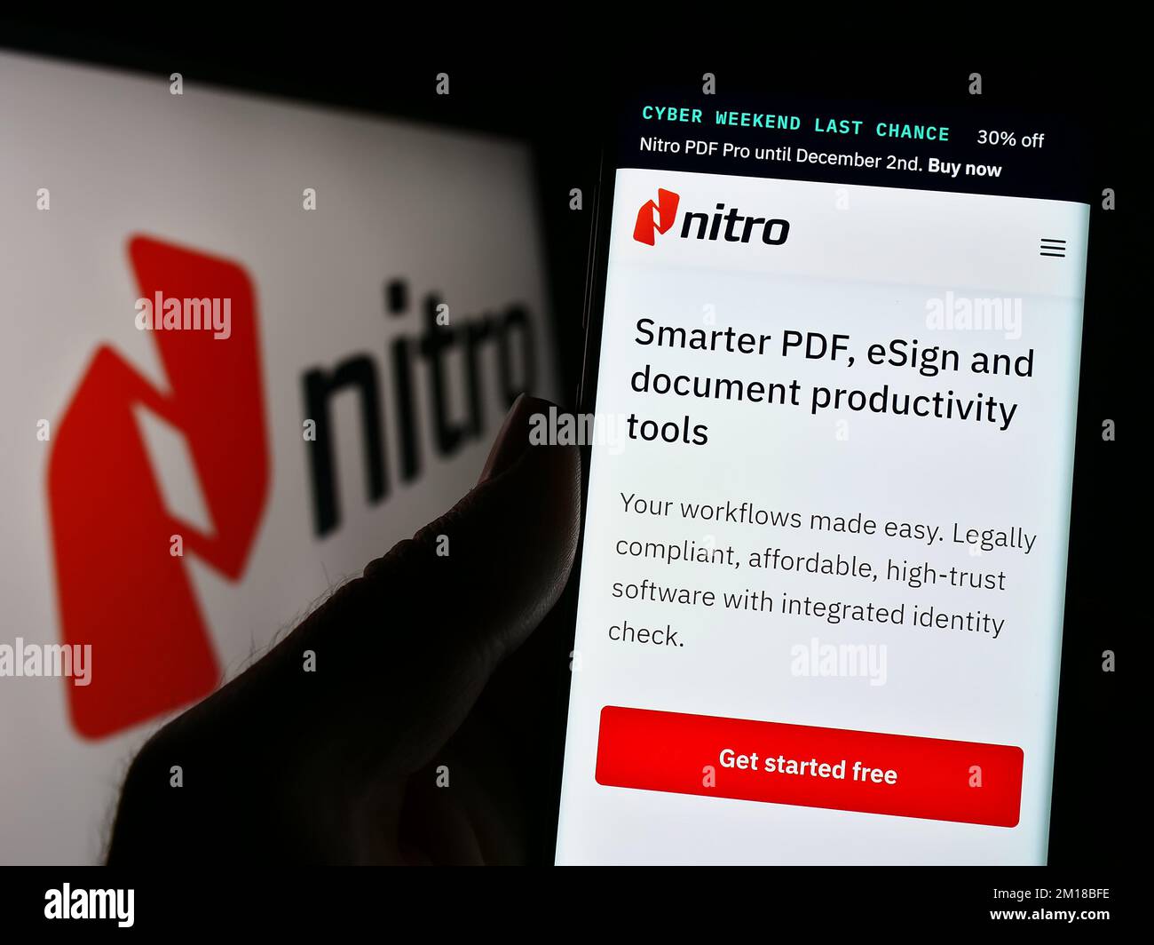 Person holding cellphone with website of software company Nitro Inc. on ...