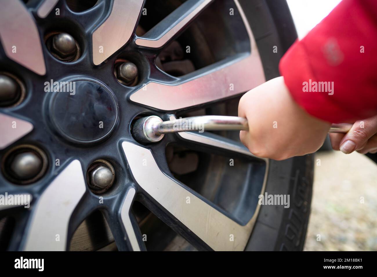 woman changing a tyre in the country. girl mechanic changing a tire in ...