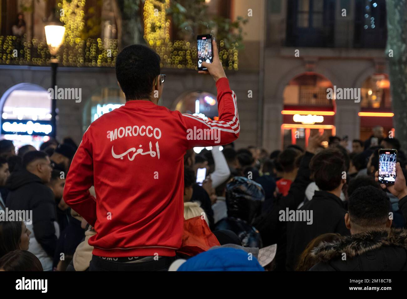 A supporter is seen wearing a red tracksuit of the soccer team. The ...