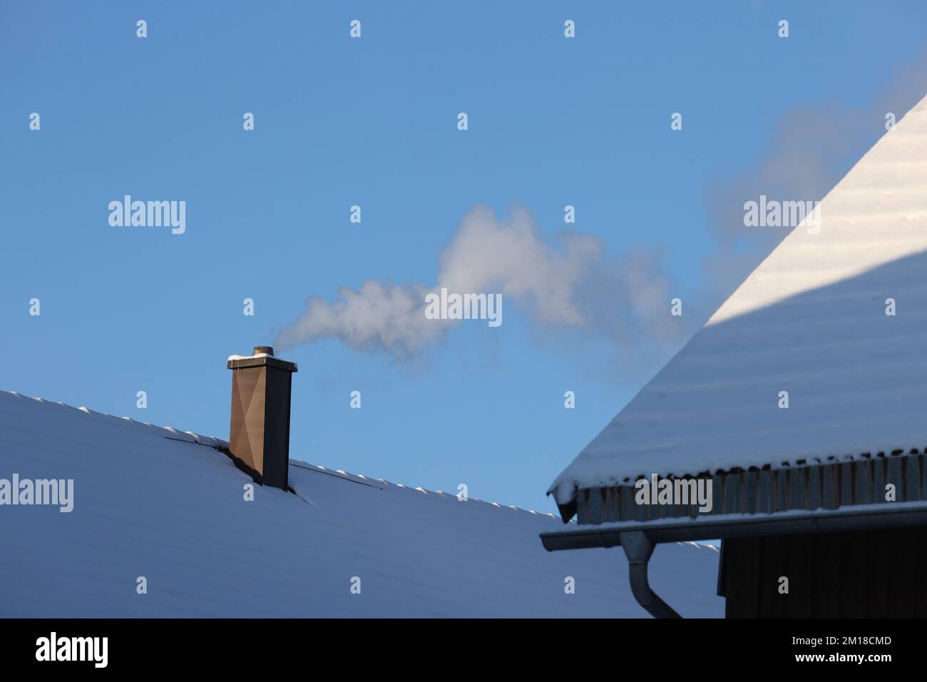 Ruderatshofen, Germany. 11th Dec, 2022. A smoking chimney stands on a ...