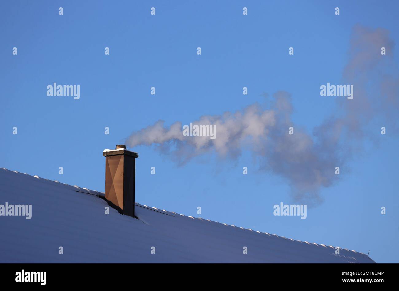 Ruderatshofen, Germany. 11th Dec, 2022. A smoking chimney stands on a ...