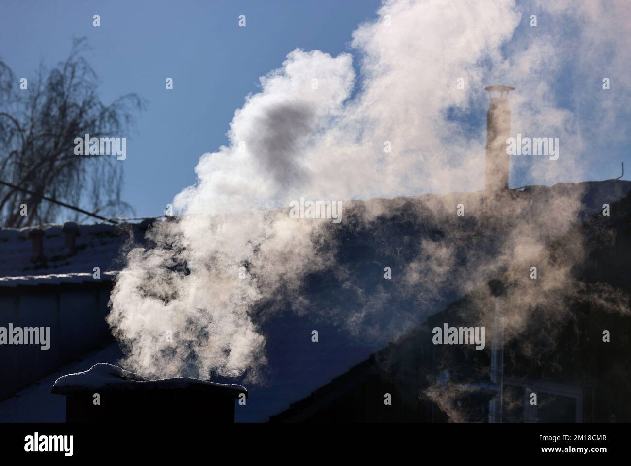 Ruderatshofen, Germany. 11th Dec, 2022. A smoking chimney stands on a ...
