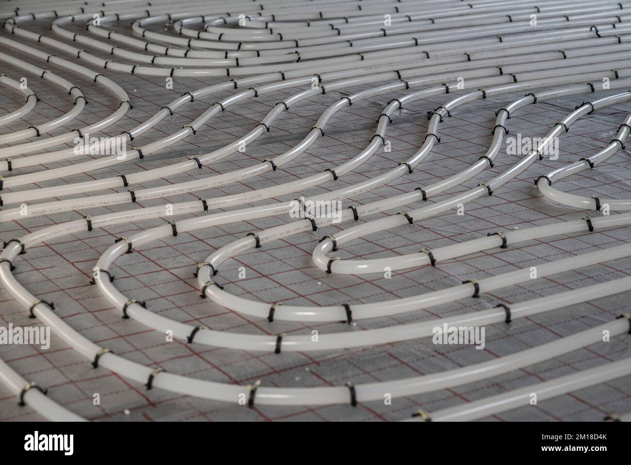 The winding tubes of the hydronic radiant heating system on the floor ...