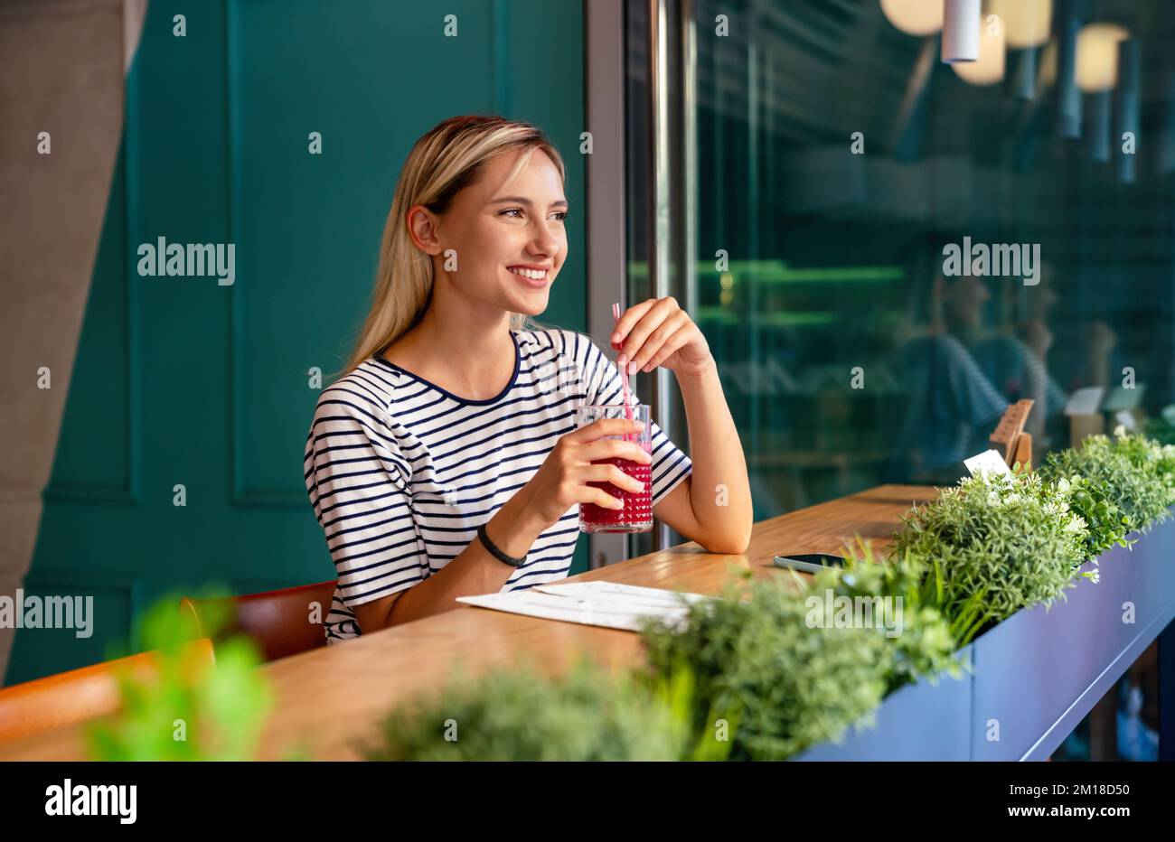 Young woman having a good morning healthy smoothie drink made of super ...