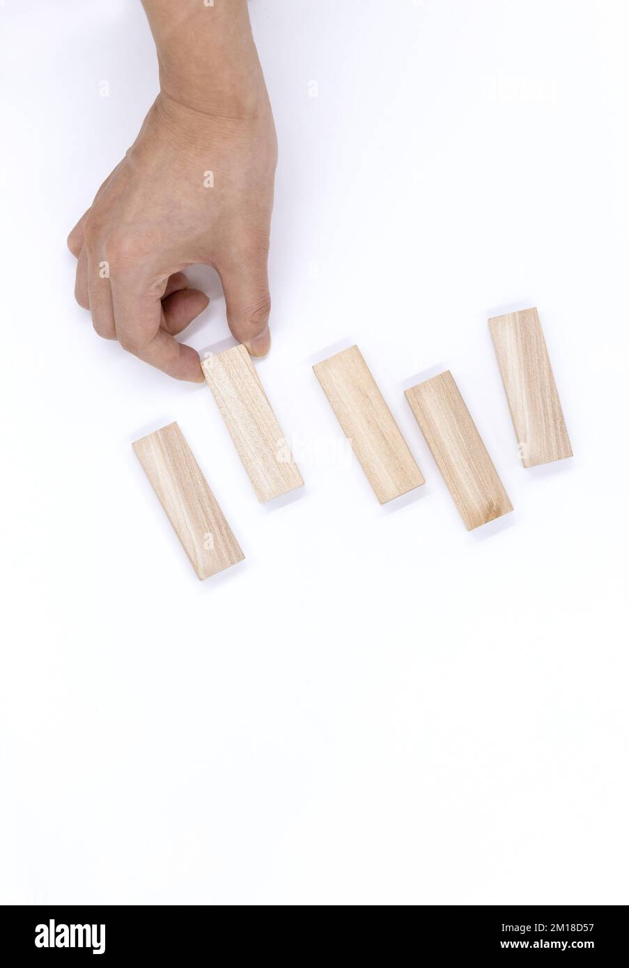 Hand pulling out one wood block, blank template Stock Photo - Alamy