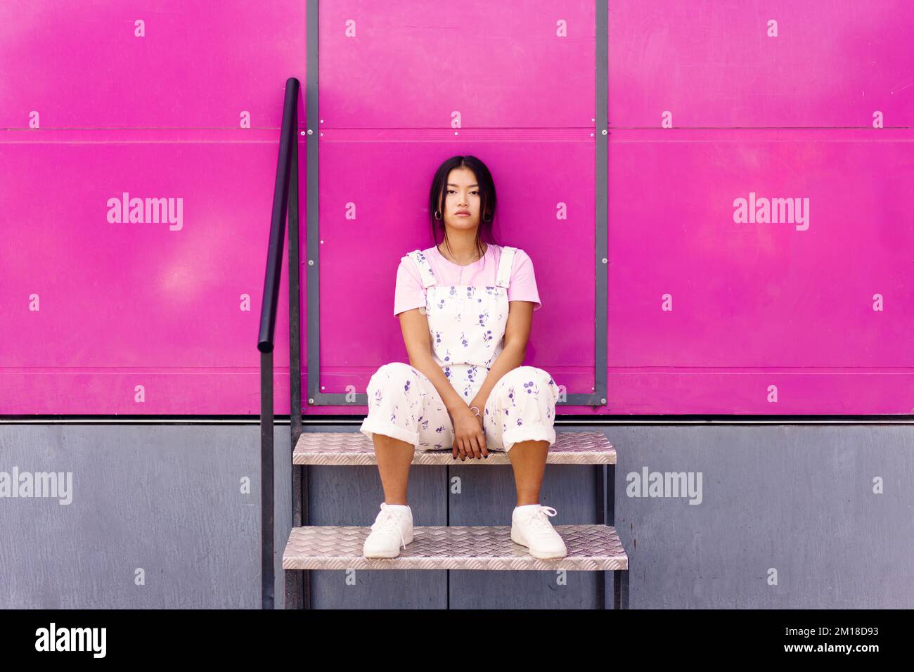 Asian woman sitting on steps Stock Photo - Alamy