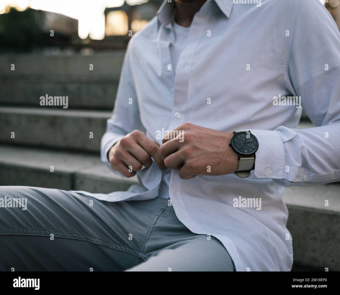 A male male businessman buttoning his shirt Stock Photo - Alamy