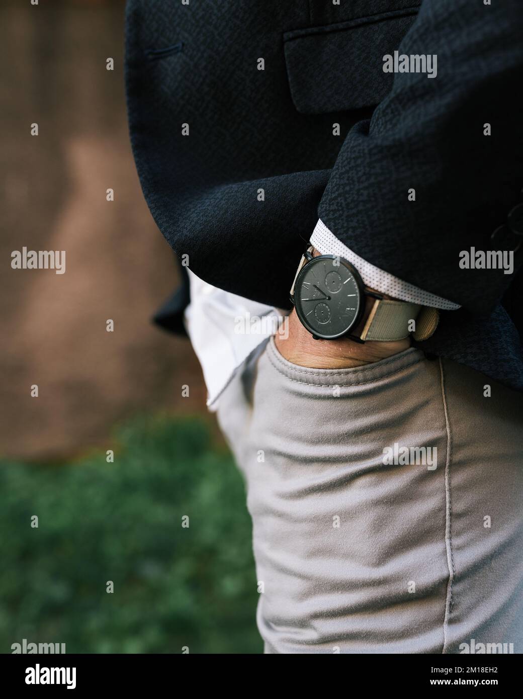 A male with a watch with hands in the pocket Stock Photo - Alamy