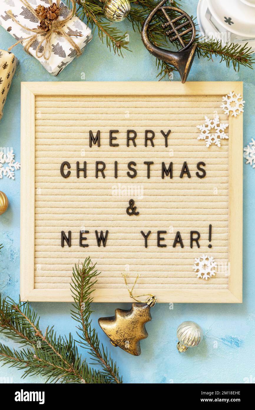 Merry Christmas lettering on letter board, gifts boxs and gold ...