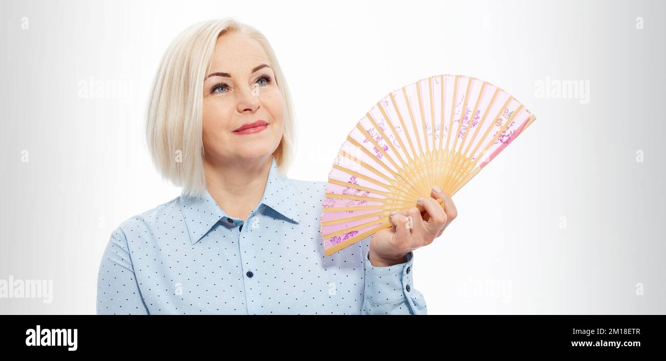 Beautiful middle aged woman with menopause blowing by fan. Hormone ...