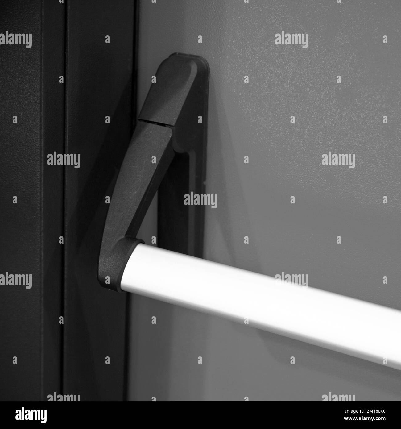 Emergency exit door. Closed up latch and black white door handle of ...
