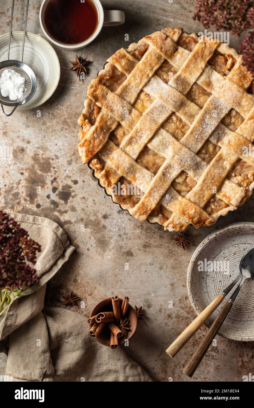 Homemade apple pie, top view table scene on brown textured background ...