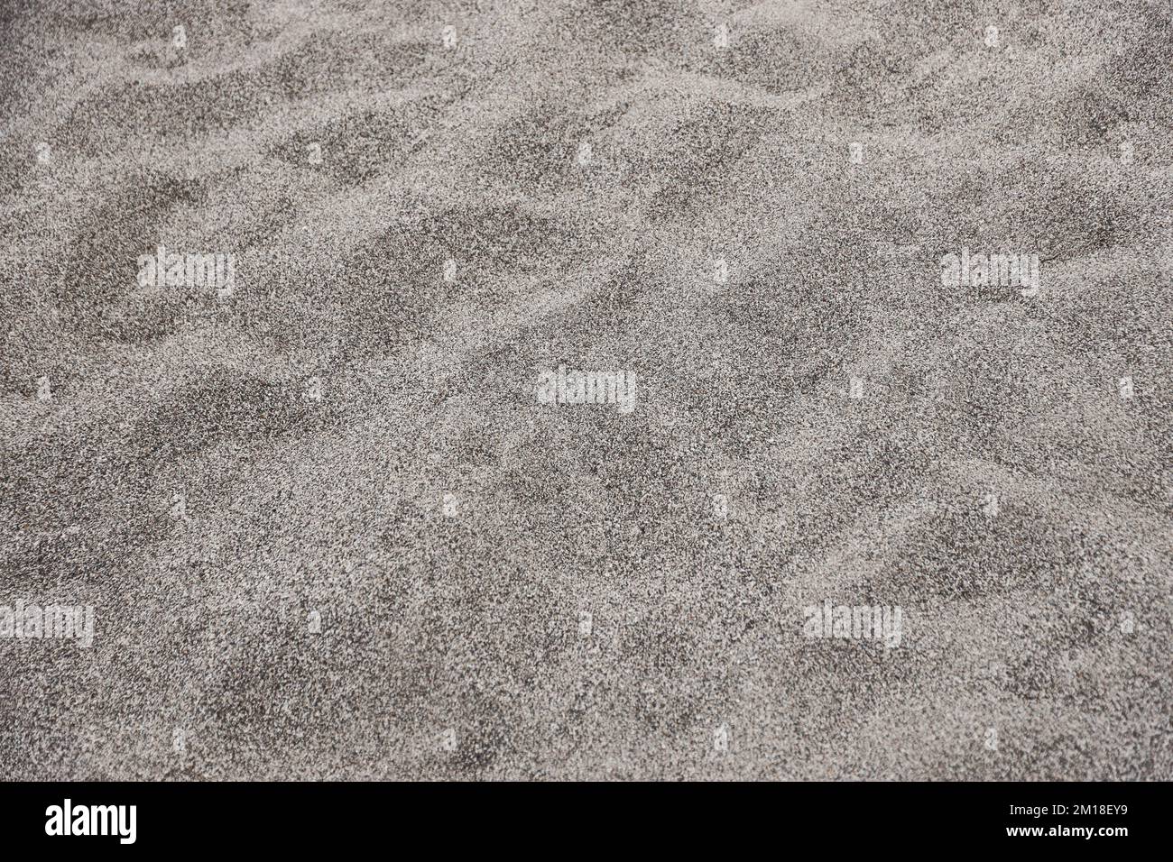 Full frame beach dark sand texture close up in daytime outdoors. Beach ...