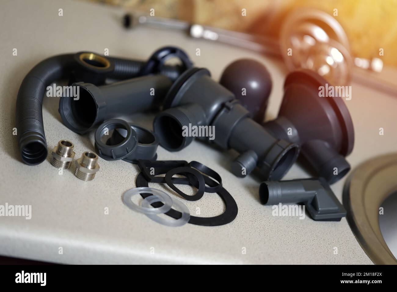 Plumbers tools and water tap ready for installation near sink on ...
