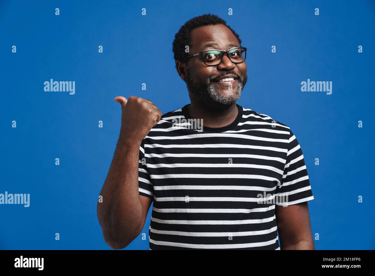 Adult african american man wearing eyeglasses smiling and gesturing ...