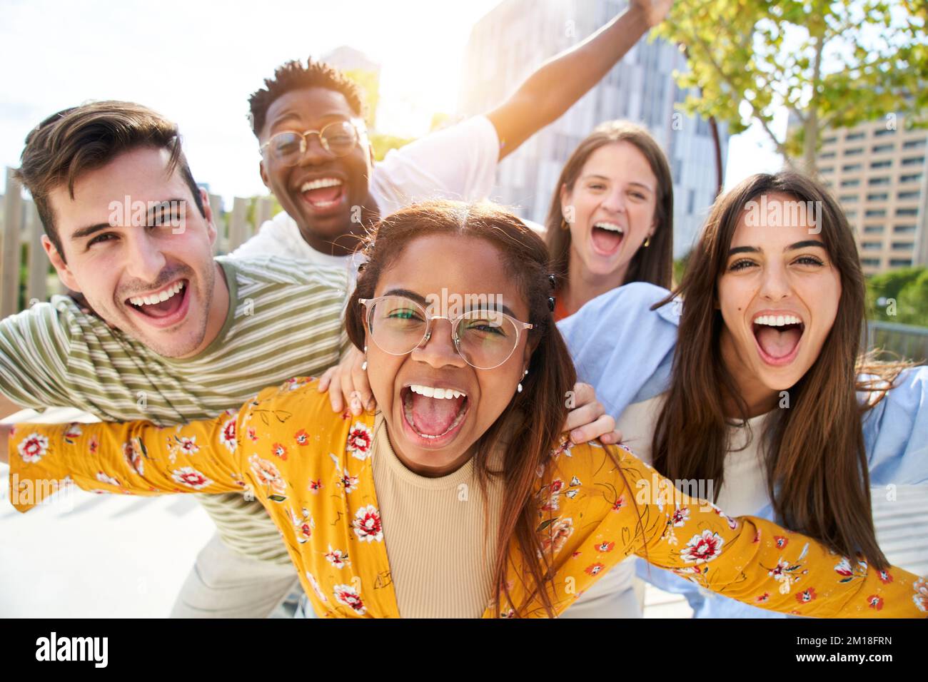 Happy Young friends looking Camera and laughing Smiling Group of people having fun together ...