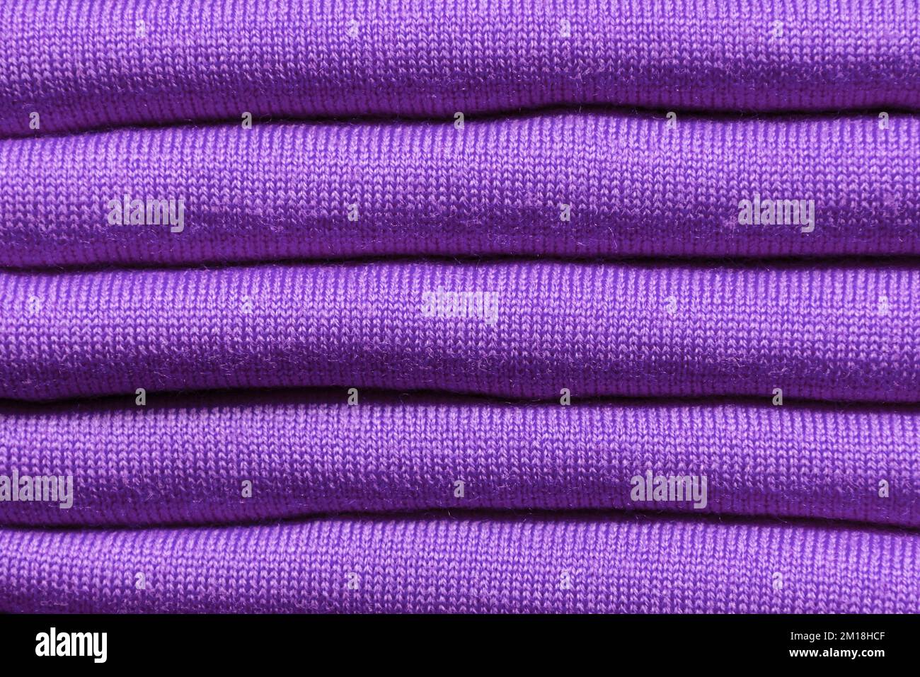 BACKGROUND TEXTURE - Folded pieces of purple knitted fabric Stock Photo ...