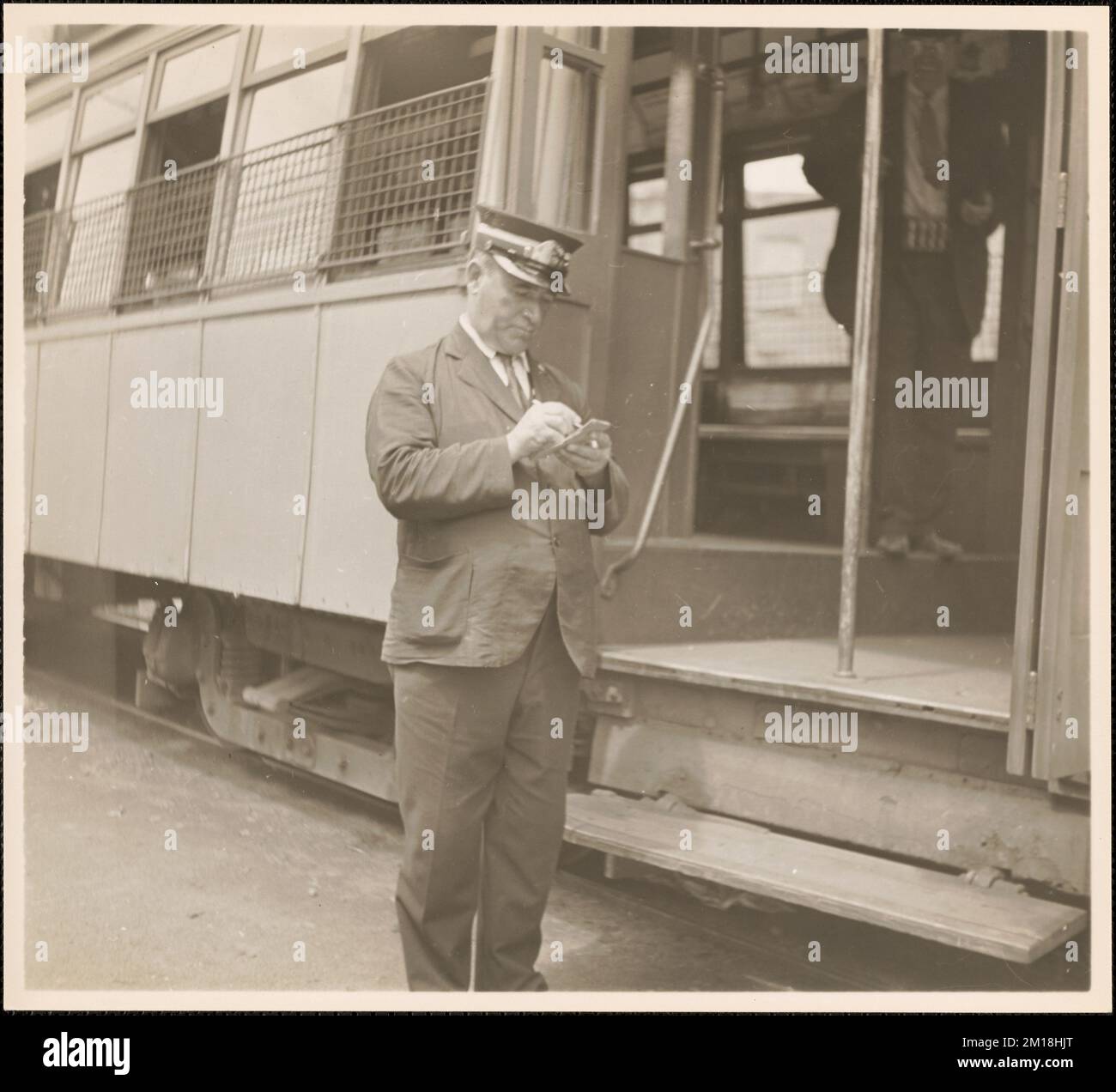 Street railroad employee writing notes , Street railroad employees ...