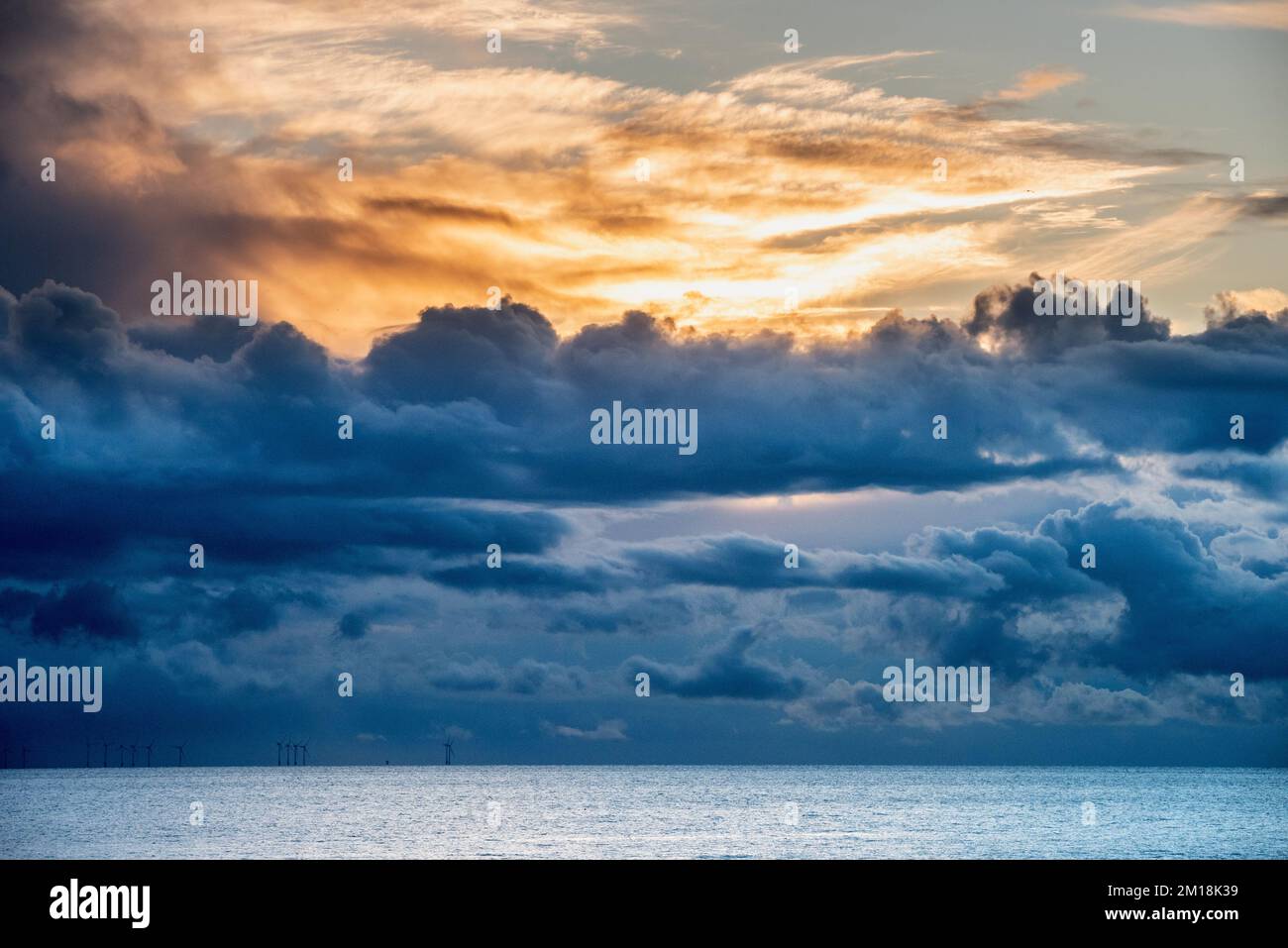 Brighton, December 10th 2022: The sun going down by the Rampion Wind ...