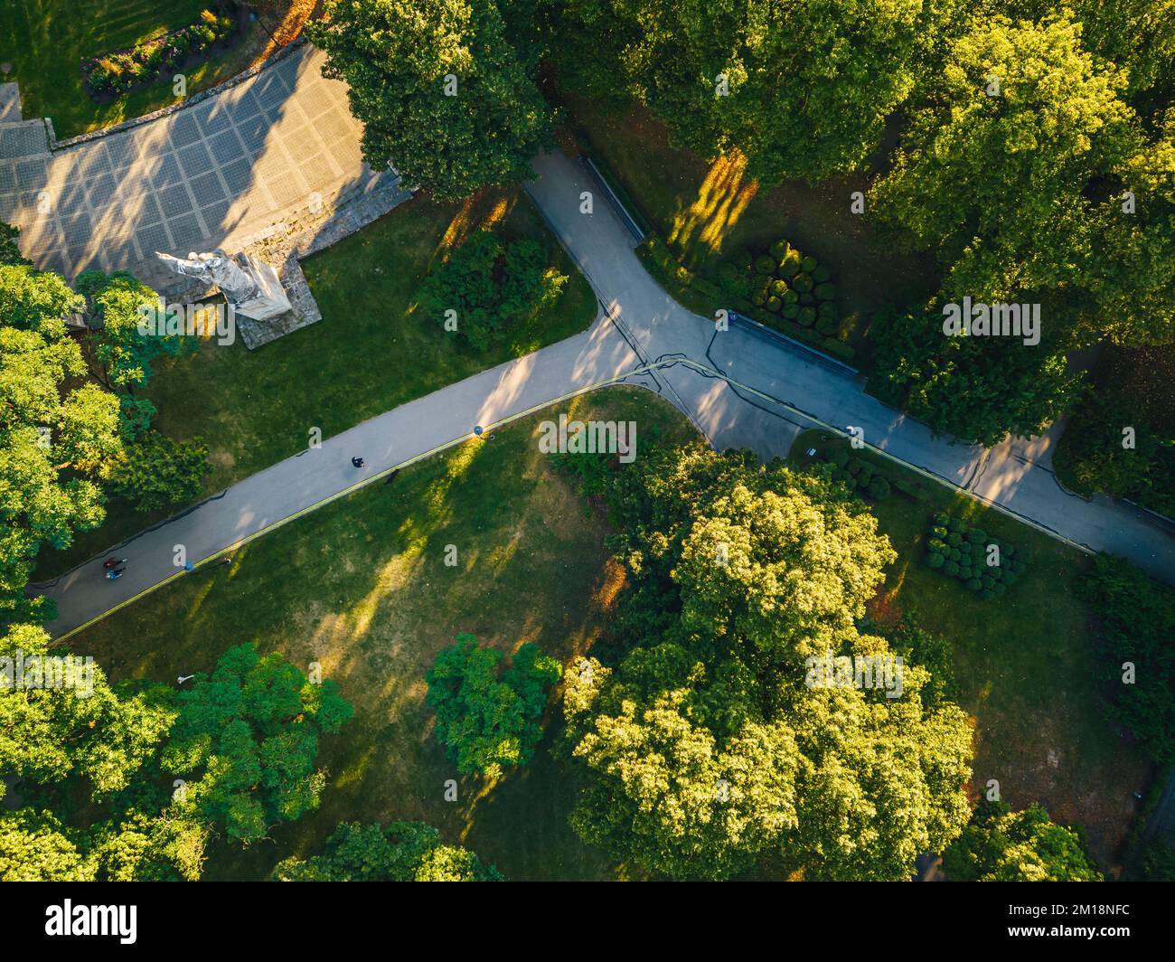A pedestrian path in the city park with green plants Stock Photo - Alamy
