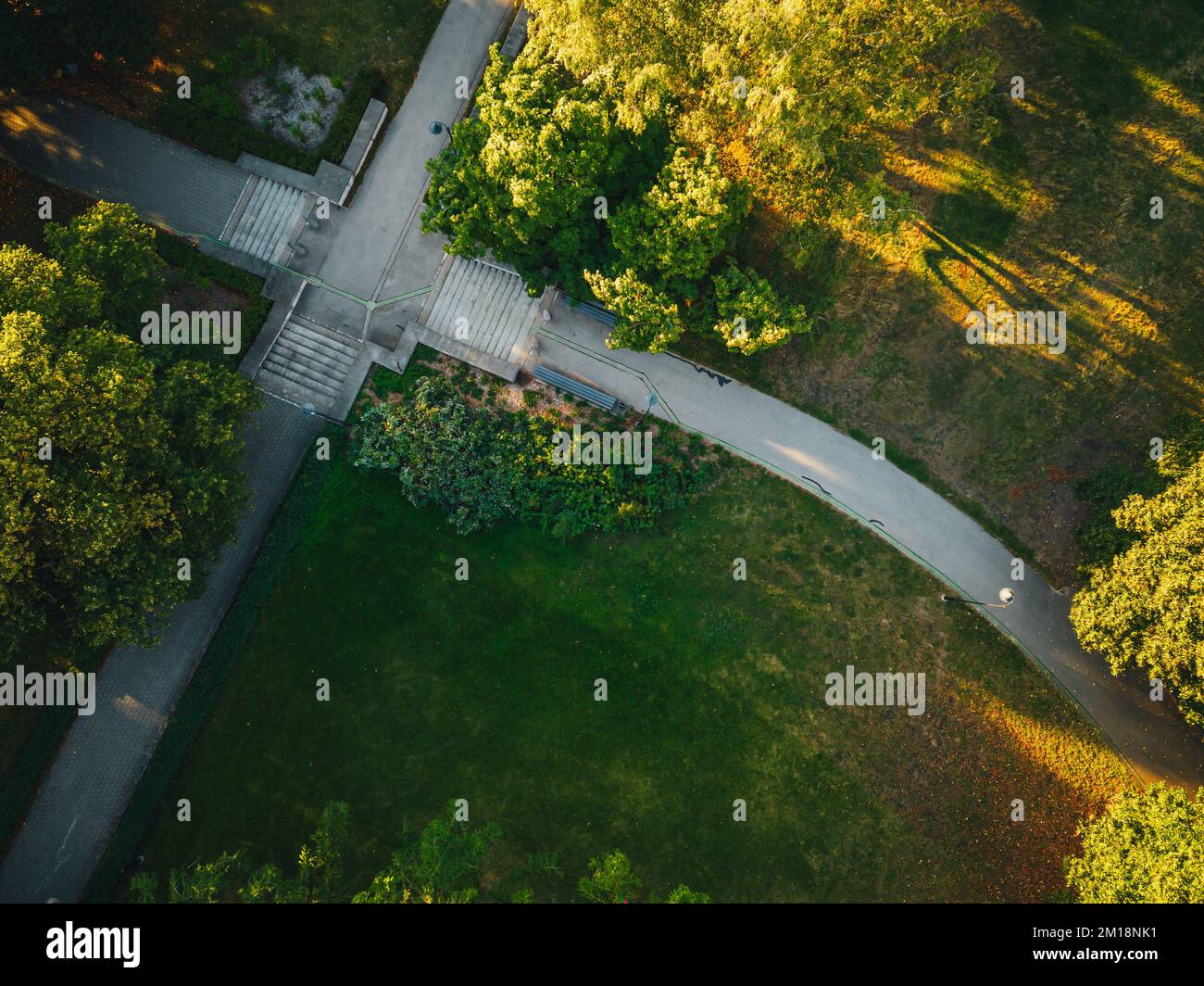 A pedestrian path in the city park with green plants Stock Photo - Alamy