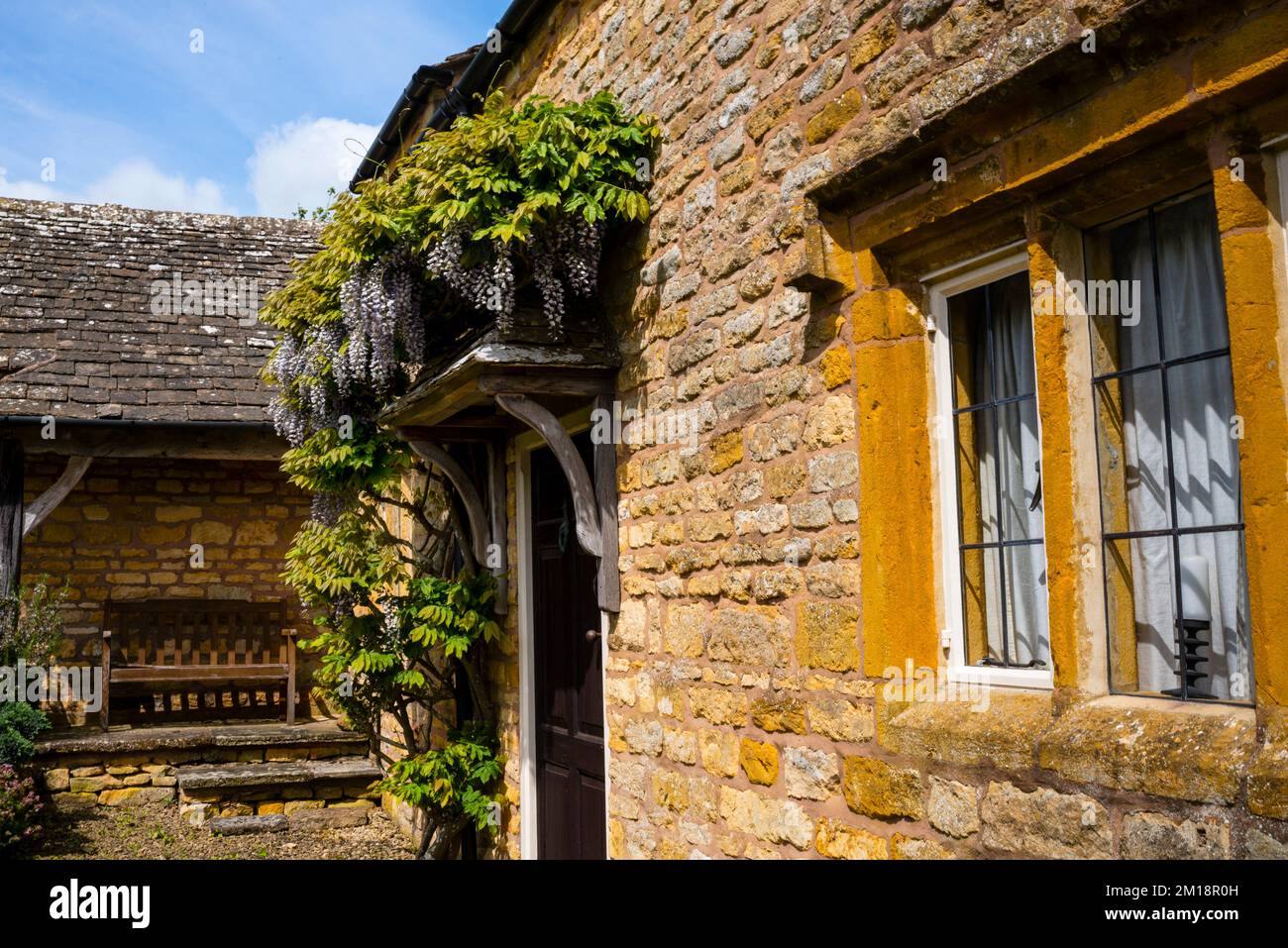 Cotswolds honey color stone, mullioned window and twining purple ...