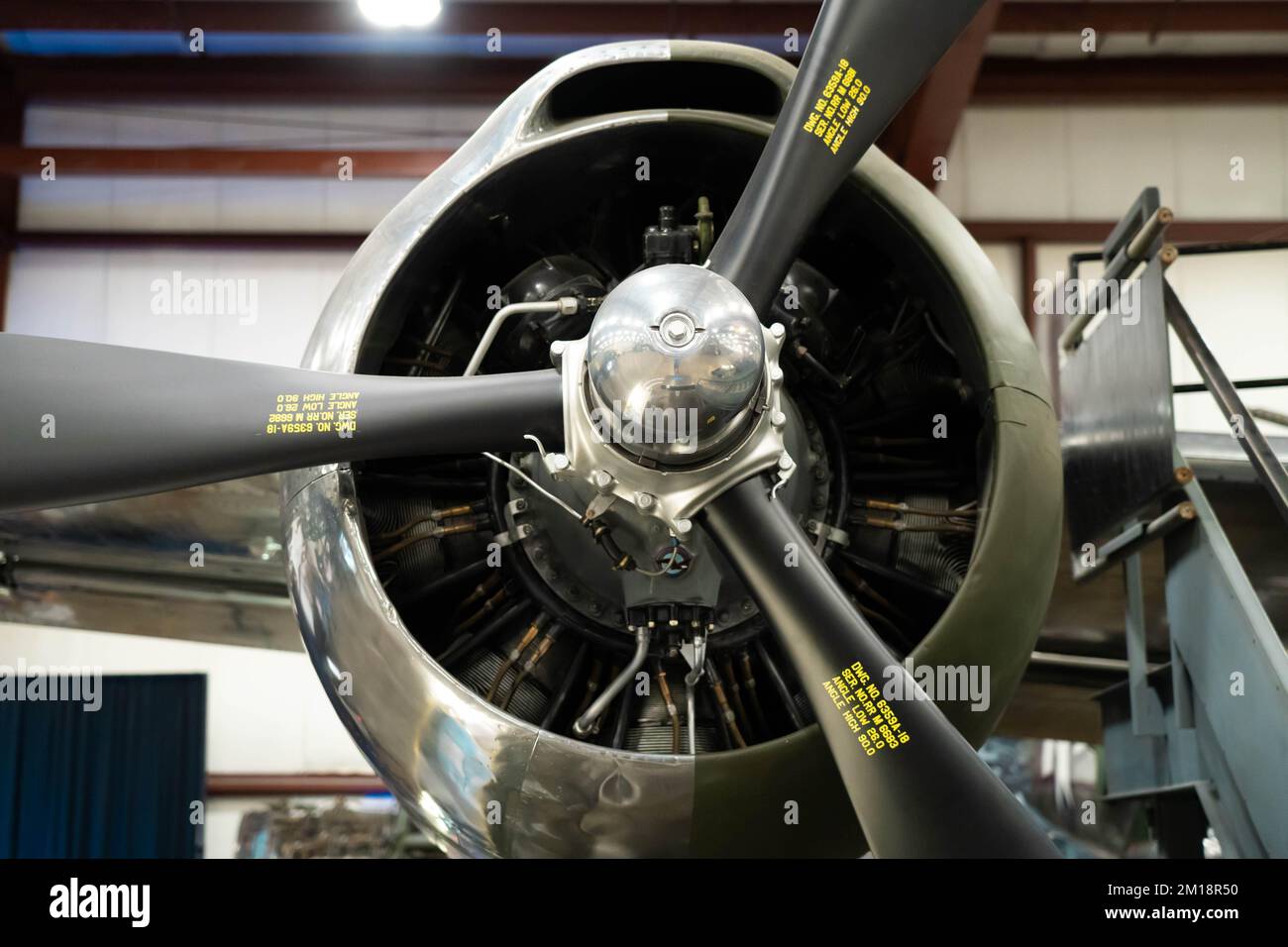 The propeller of a WWII airplane in a hangar on the blurred background ...
