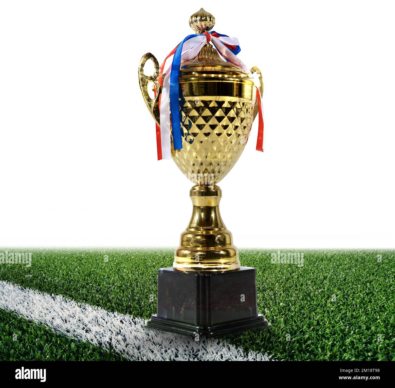 Golden soccer trophy in a football field Stock Photo - Alamy