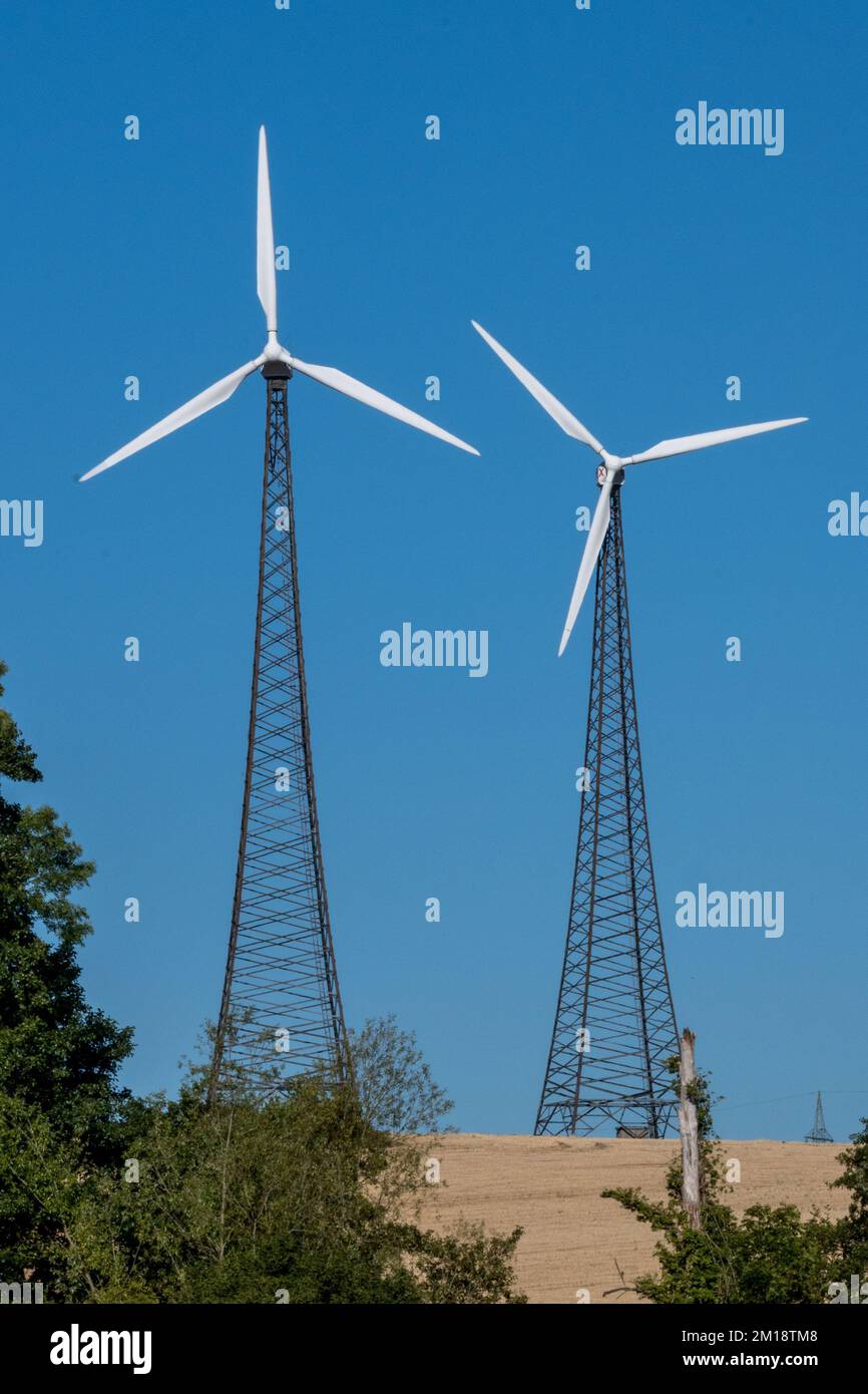 A vertical shot of wind turbines in the beautiful forest Stock Photo ...