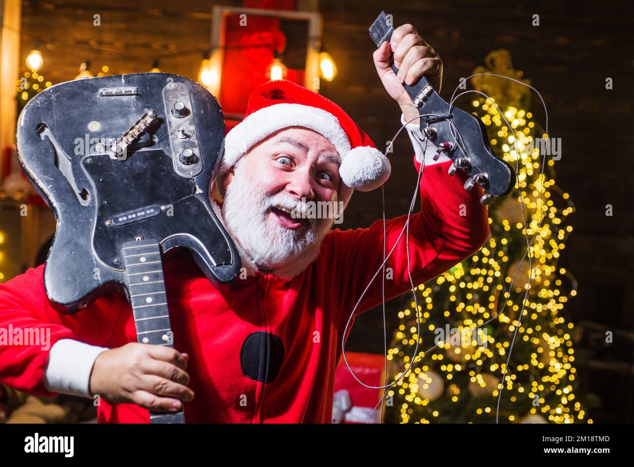 Santa Claus rock musician with broken electric guitar. Christmas and ...