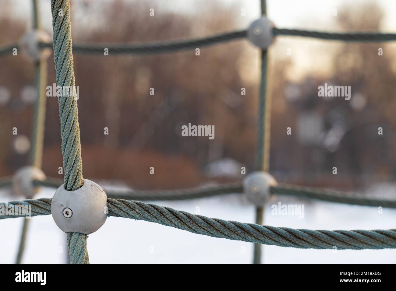 fixing a rope ladder on a sports ground. fastening rope ladder close-up ...