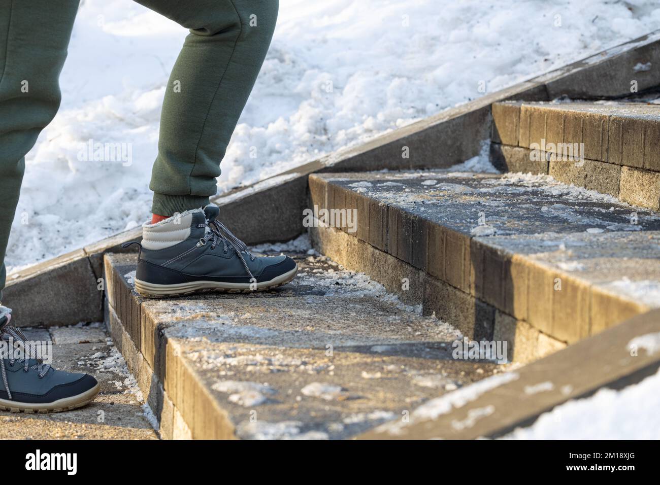 a man climbs a ladder covered with ice. ice covered steps. man climbing ...
