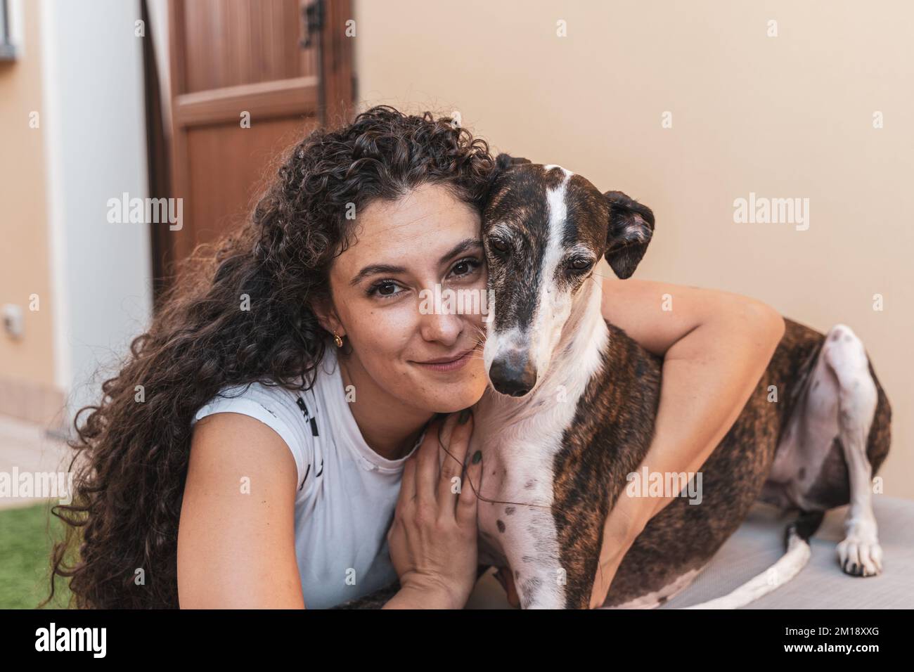 beautiful female dog trainer hugs her dog during a training break ...
