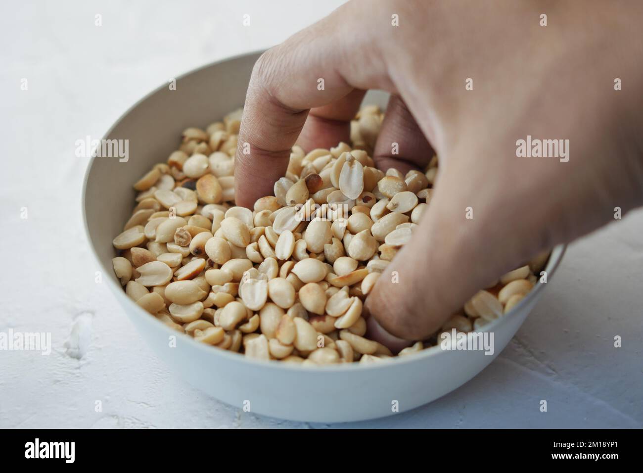 hand pick Processed peanuts in a bowl on table Stock Photo - Alamy