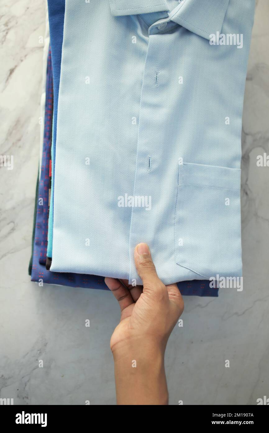 Putting on new shirts hi-res stock photography and images - Alamy